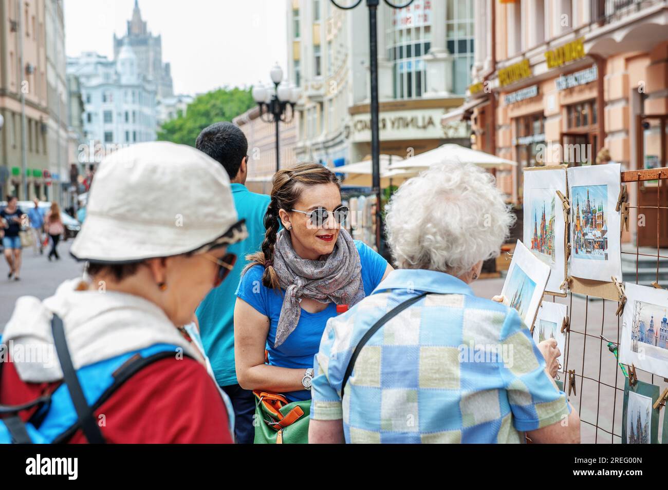 Stary Arbat, Moscow, Russia July 9, 2015. Tourists look at paintings in ...