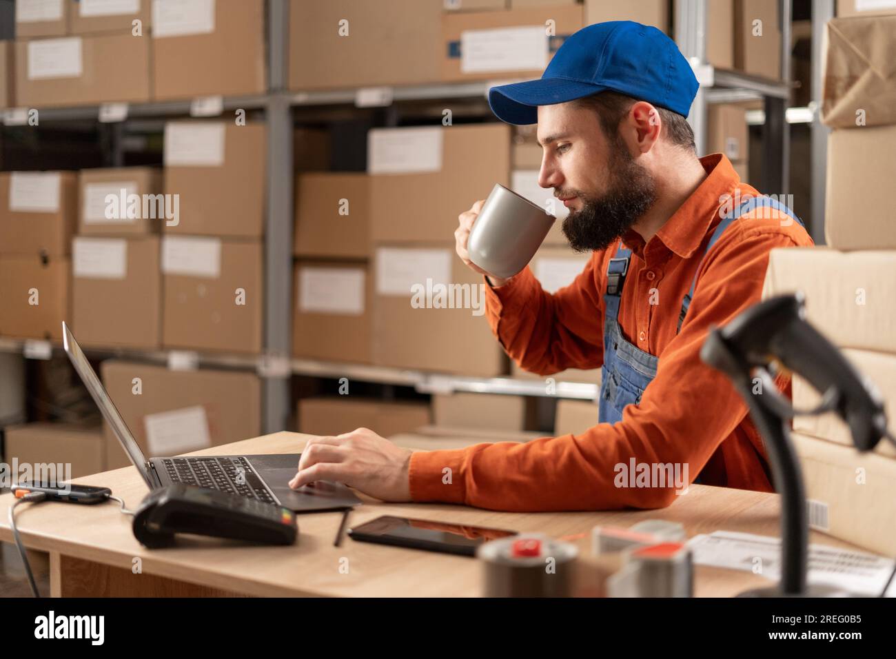 Professional male worker using laptop computer checking stock and ...