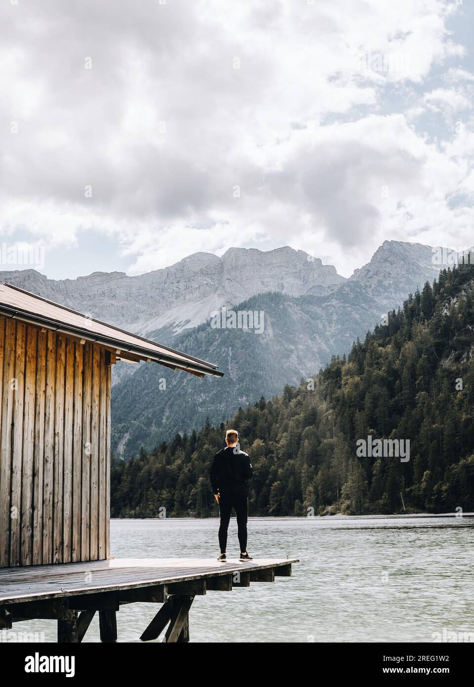 Person in front of Plansee in Austrian mountains close to Germany ...