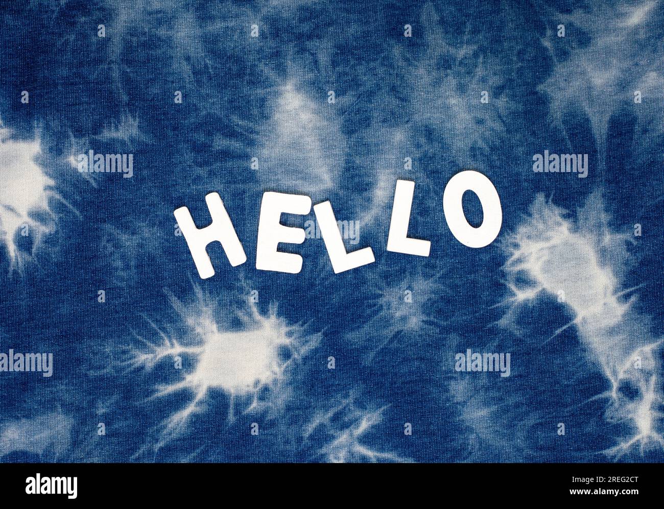 Hello written in white lettering on full frame grunge blue tie dye ...