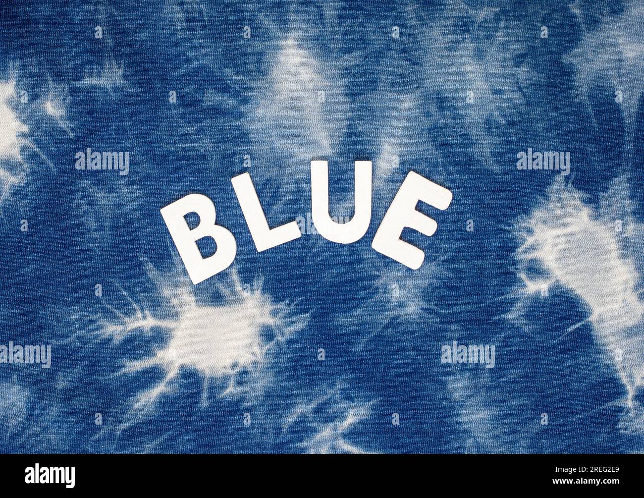 Blue written in white lettering on full frame grunge blue tie dye ...