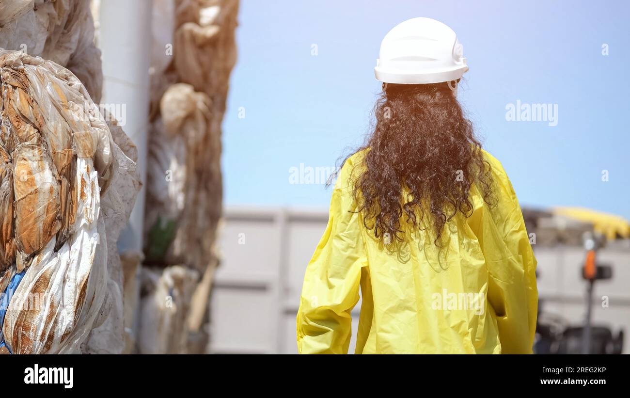Black-haired lady inspector explores waste sorting plant Stock Photo ...