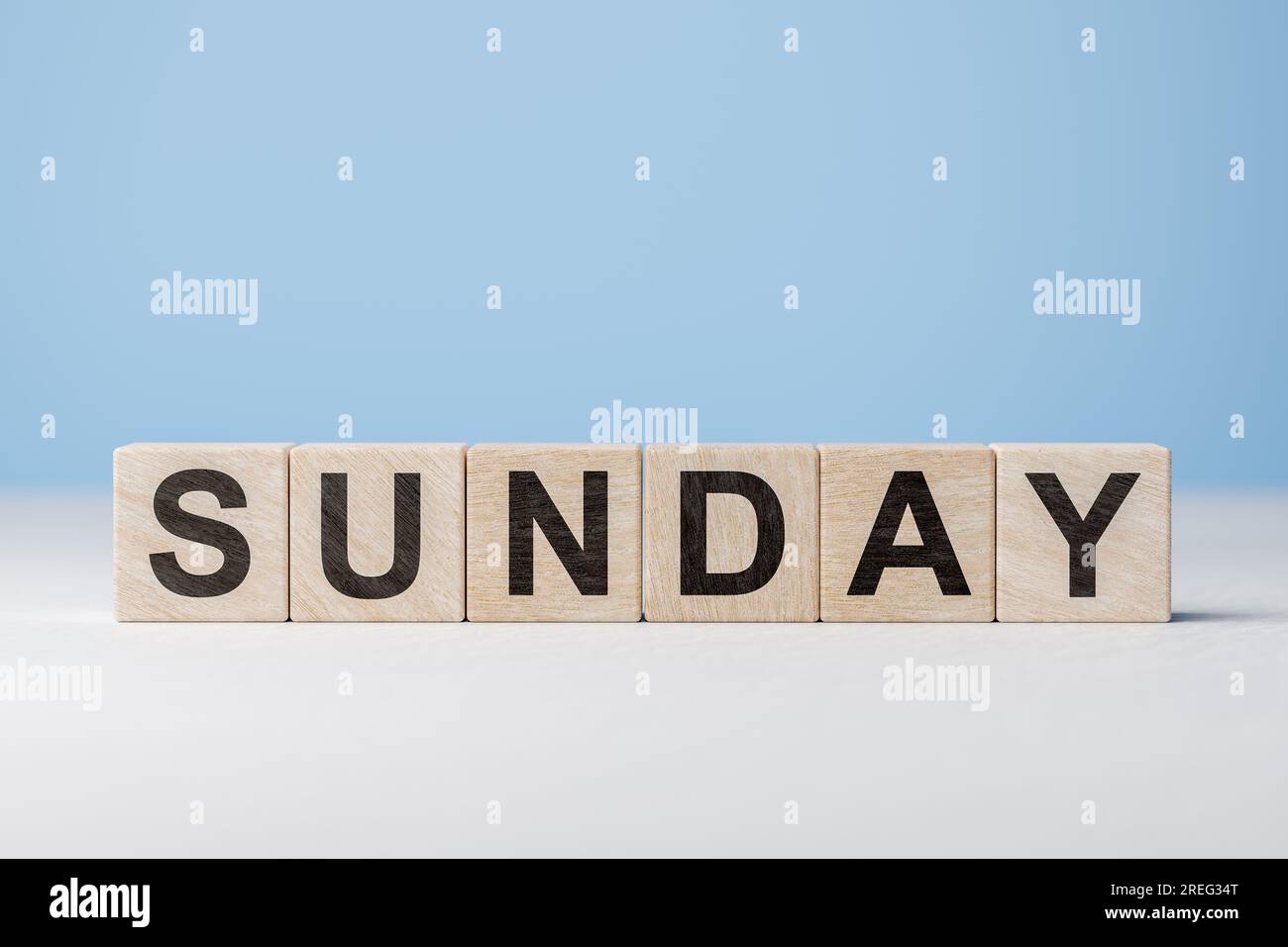 Text Sunday on wooden cubes on blue background. Day of week on wood ...
