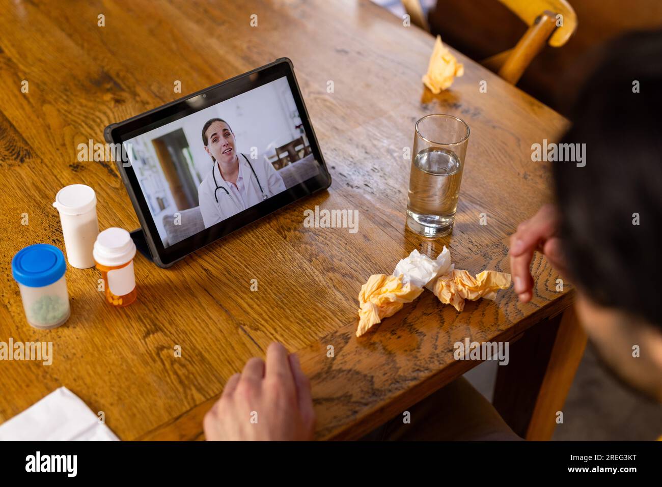 Indian man with medication on table making video call using tablet at ...