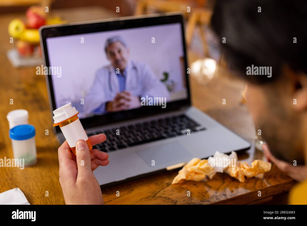 Indian man holding medication making video call using tablet at home ...