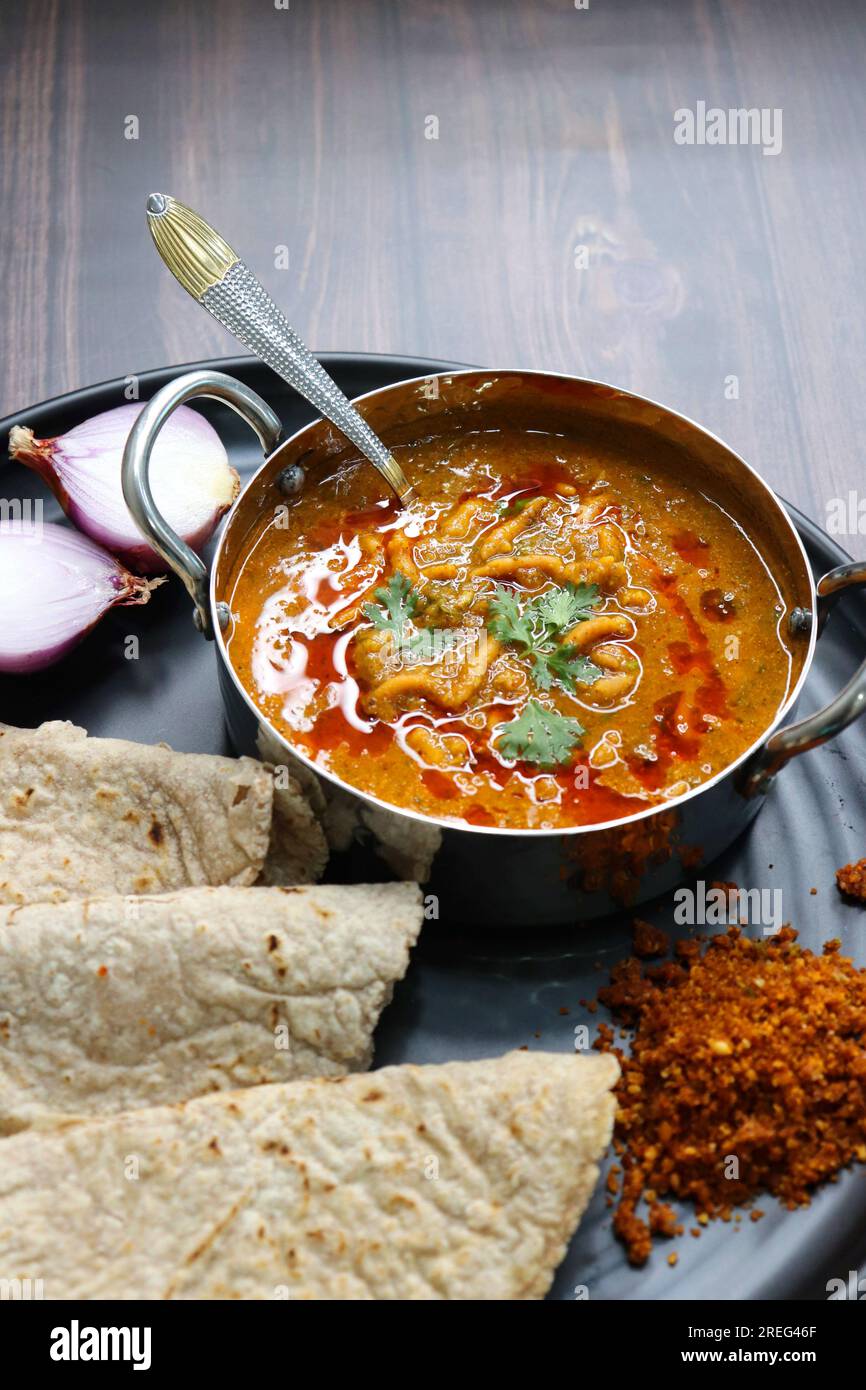 Traditional Sev bhaji or sev tamatar nu Shaak with Jowar Bhakri. Sev is ...