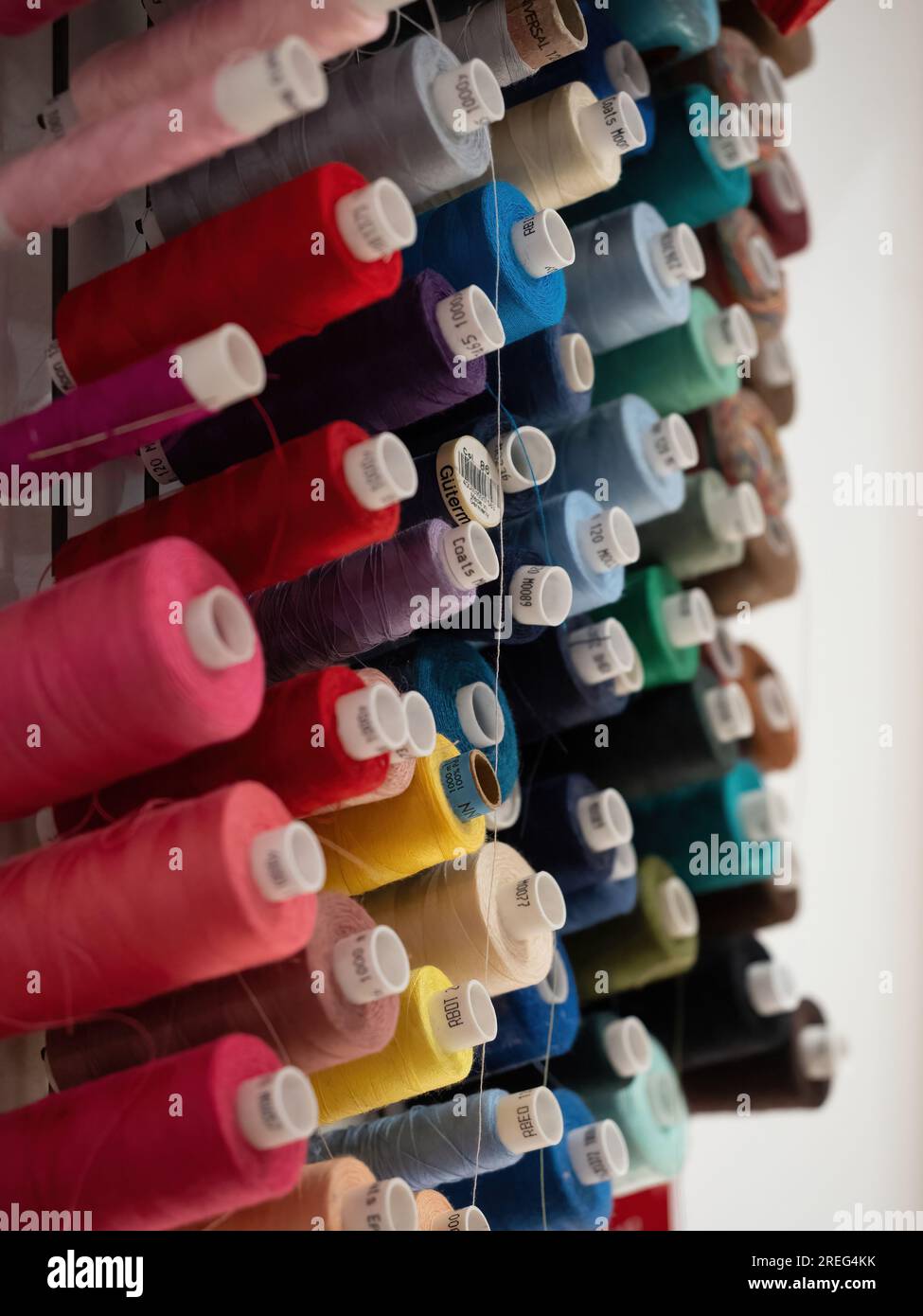 A rack of multi-coloured thread on bobbins Stock Photo - Alamy