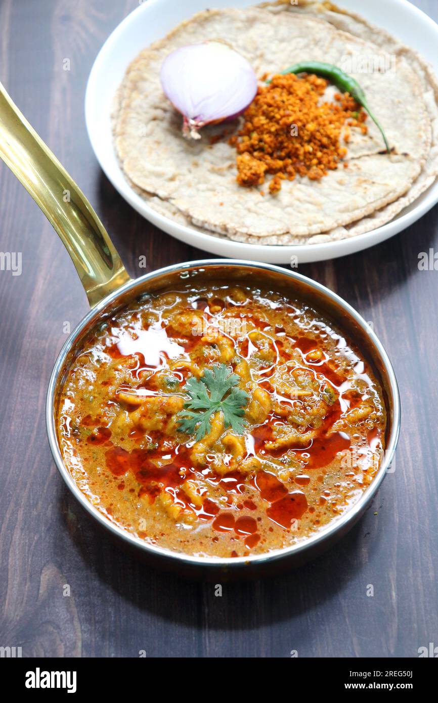 Traditional Sev bhaji or sev tamatar nu Shaak with Jowar Bhakri. Sev is ...