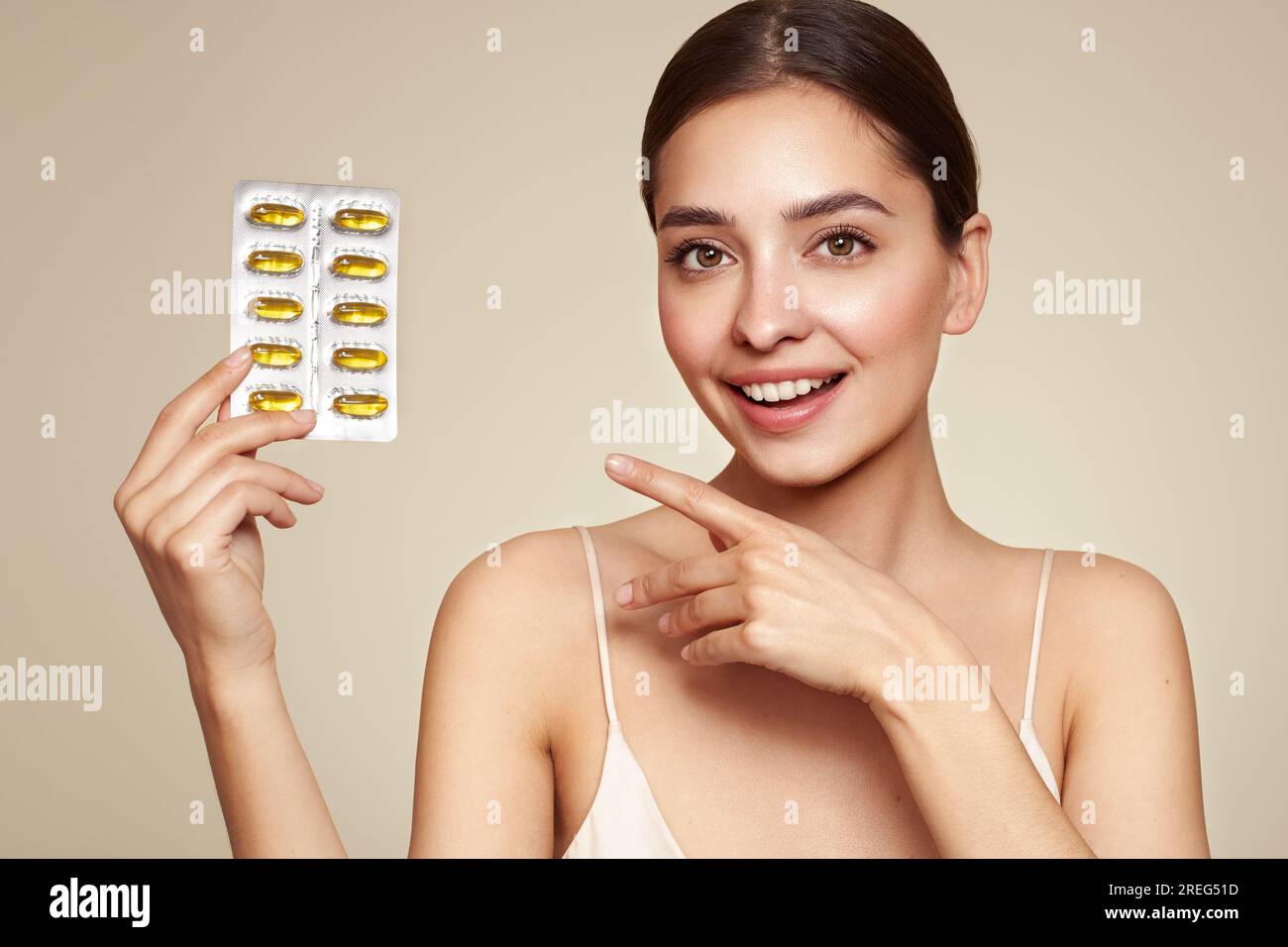Vitamins. Close Up Of Happy Beautiful Girl With Pill With Cod Liver Oil ...