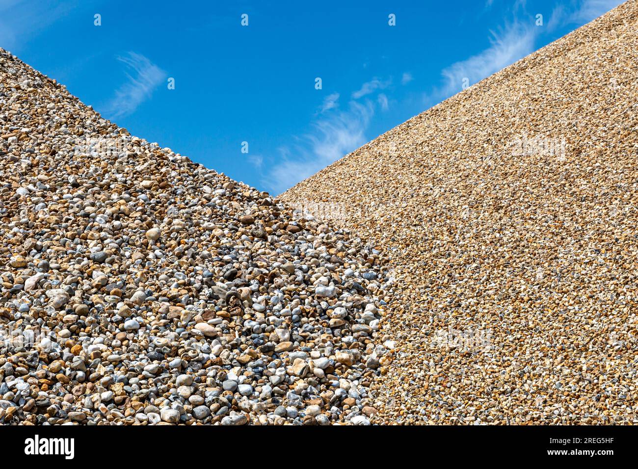 An abundance of pebbles sorted into small and large piles, with a blue ...