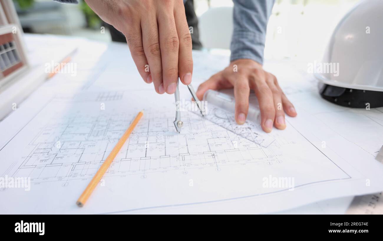 designer drawing graphic design of building project, improvement at ...