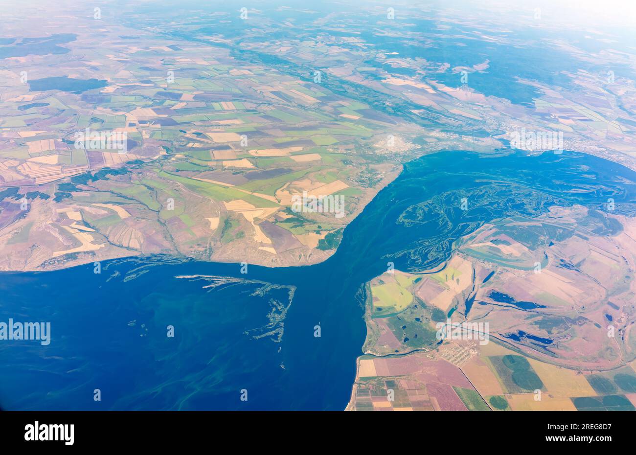Aerial view from airplane window above green ground. View from the ...
