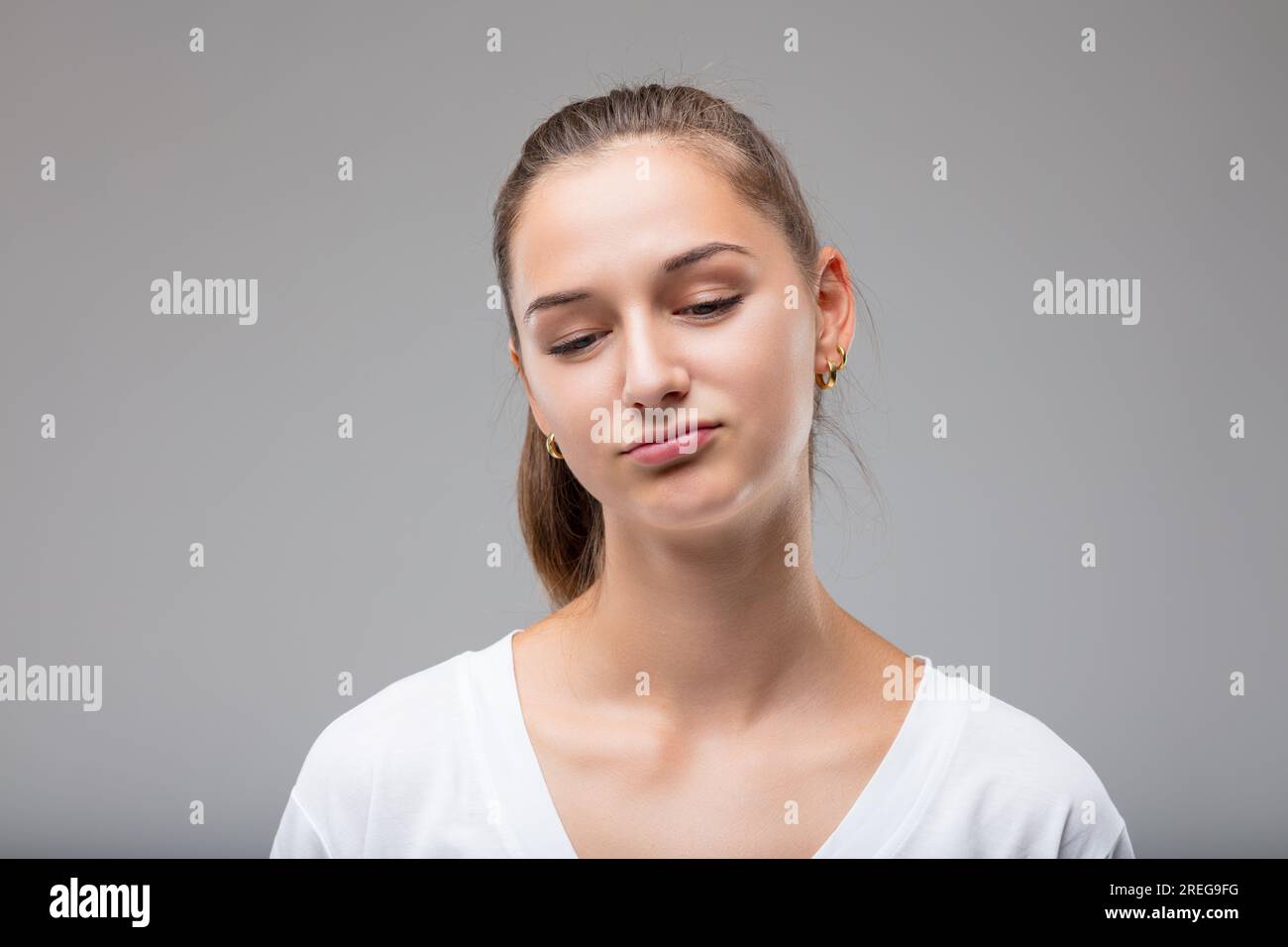 The young woman's face displays obvious discontent; her emotions signal ...