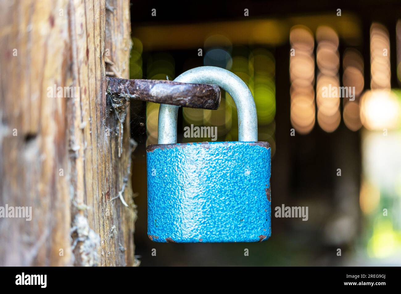 Locked old iron lock in the barn Stock Photo - Alamy