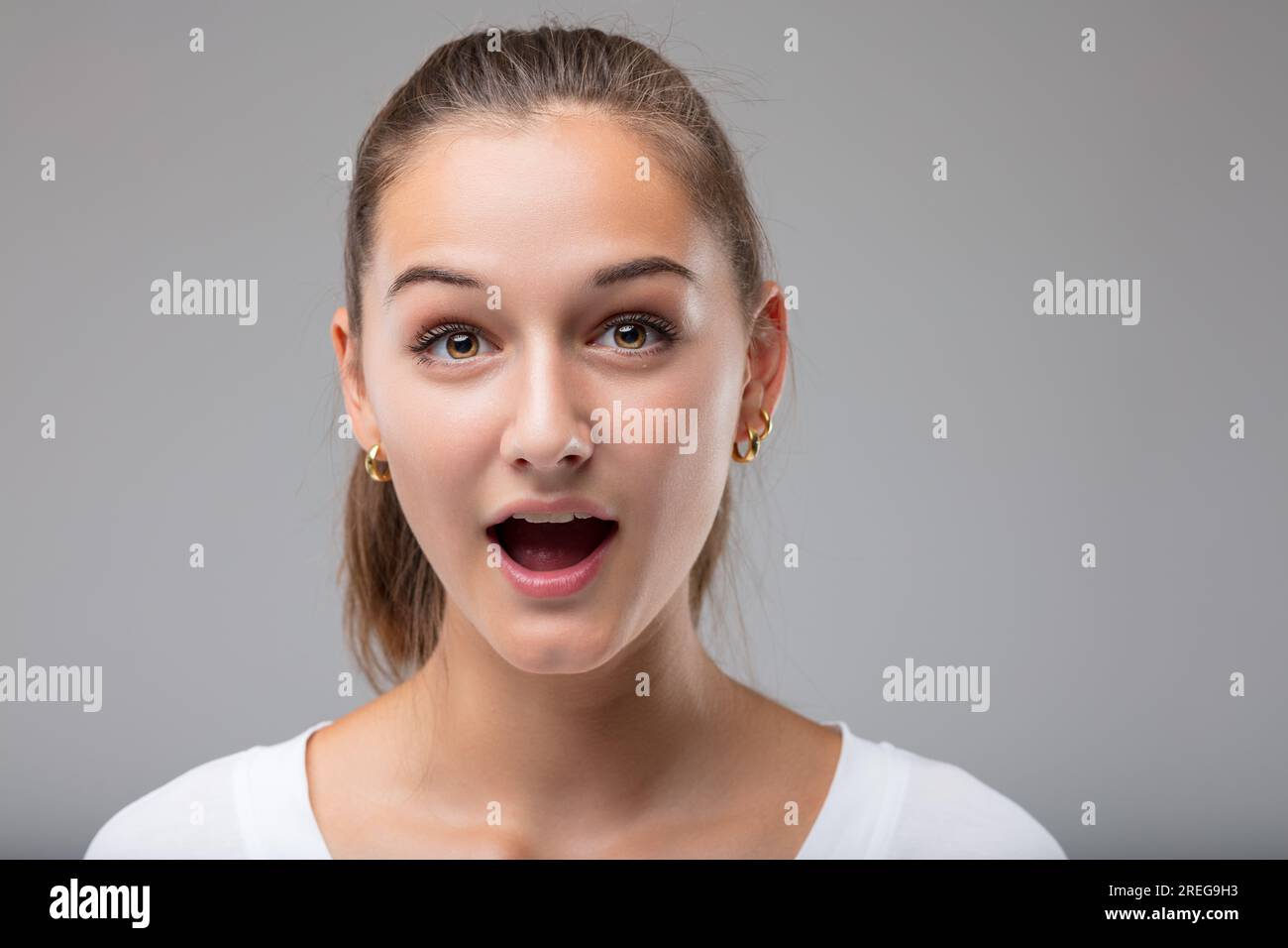 Captivating! A young woman's face lights up with joy and surprise as ...
