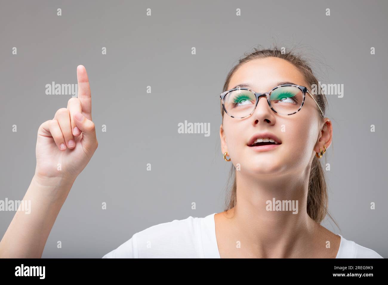 A young woman's face indicates intense thinking, hinting at a ...