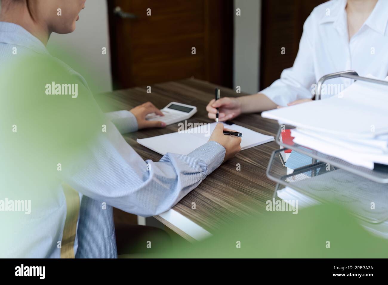 Real Estate Agent explain insurance and agreement contract to client ...