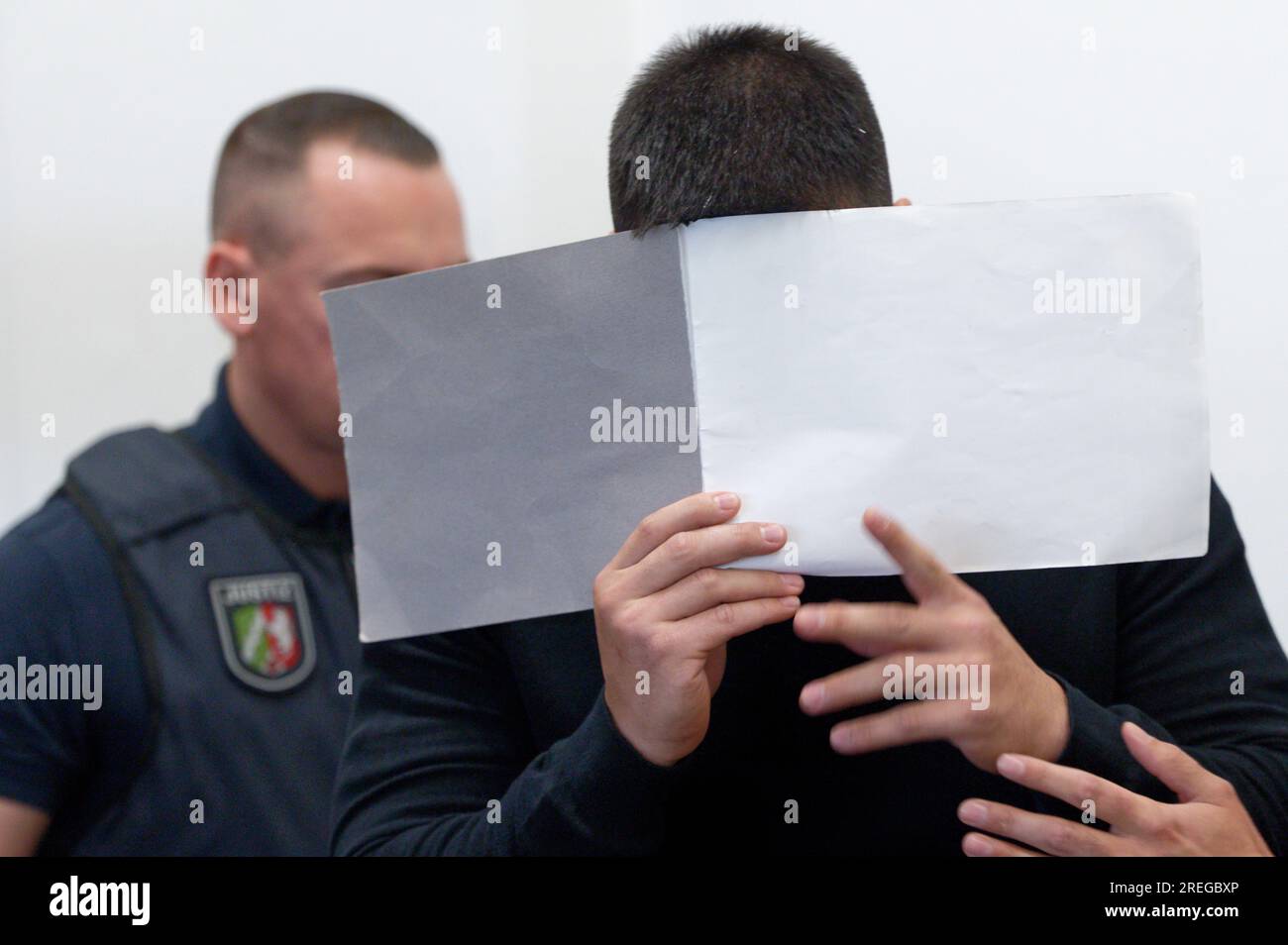 Cologne, Germany. 28th July, 2023. The defendant arrives in a courtroom ...