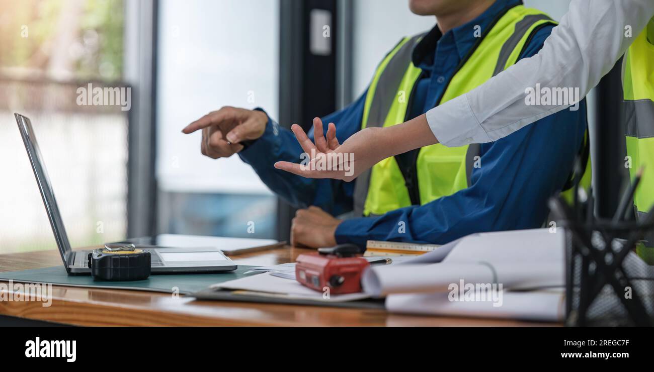 Two Engineer Working In Office With Blueprints Inspection In Workplace