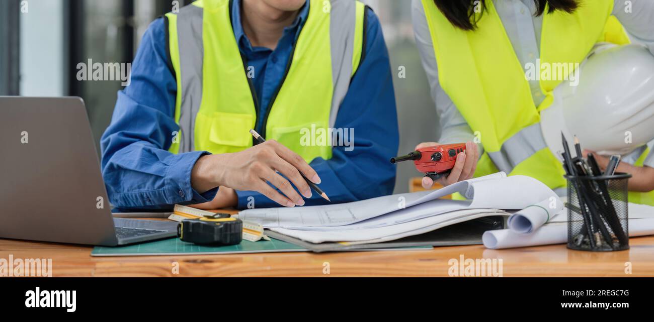 Two engineer working in office with blueprints, inspection in workplace ...