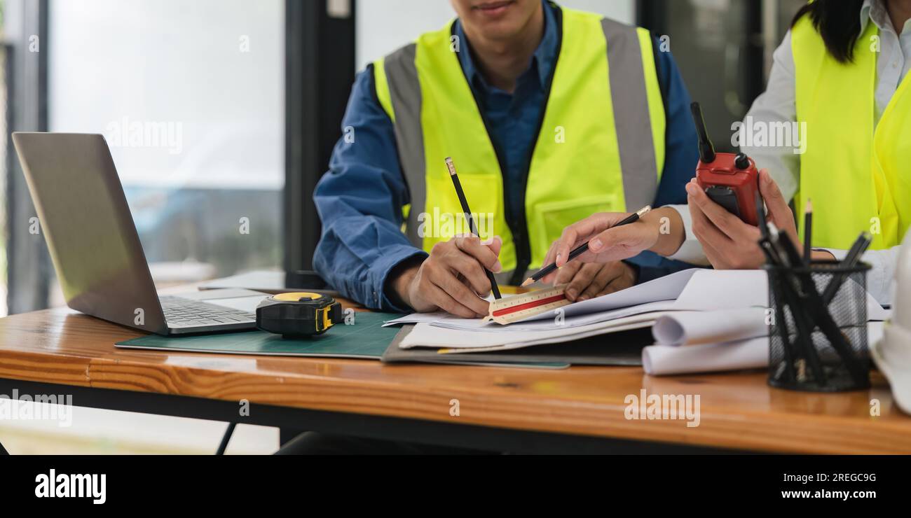 Two engineer working in office with blueprints, inspection in workplace ...