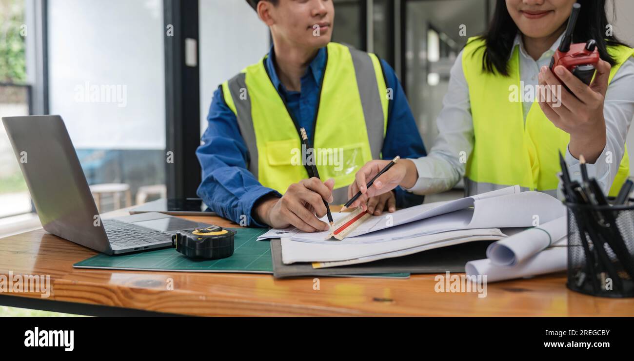 Two engineer working in office with blueprints, inspection in workplace ...