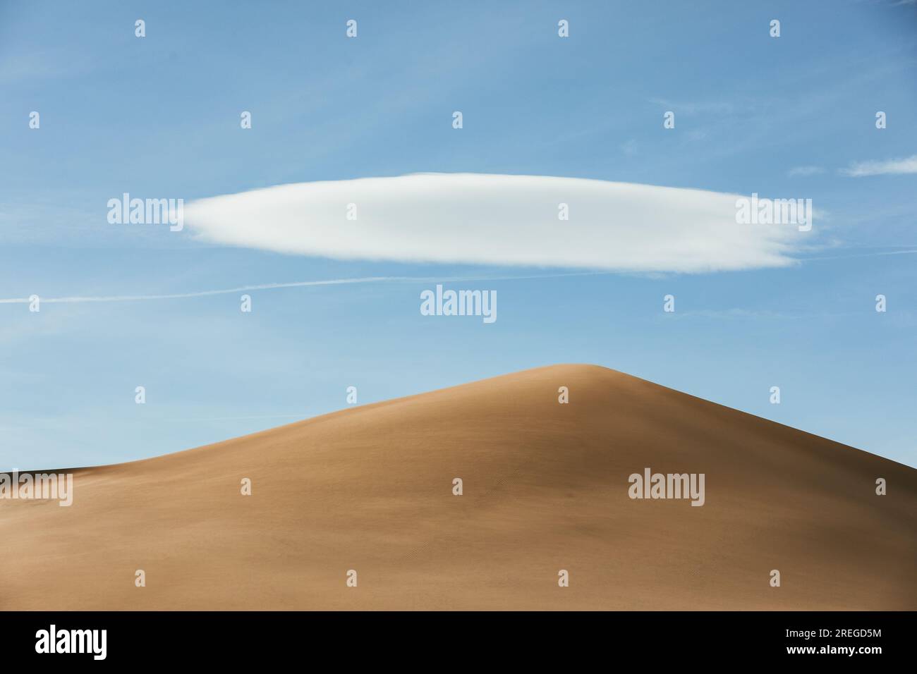 golden tan sand dune under blue sky with one puffy white cloud Stock ...