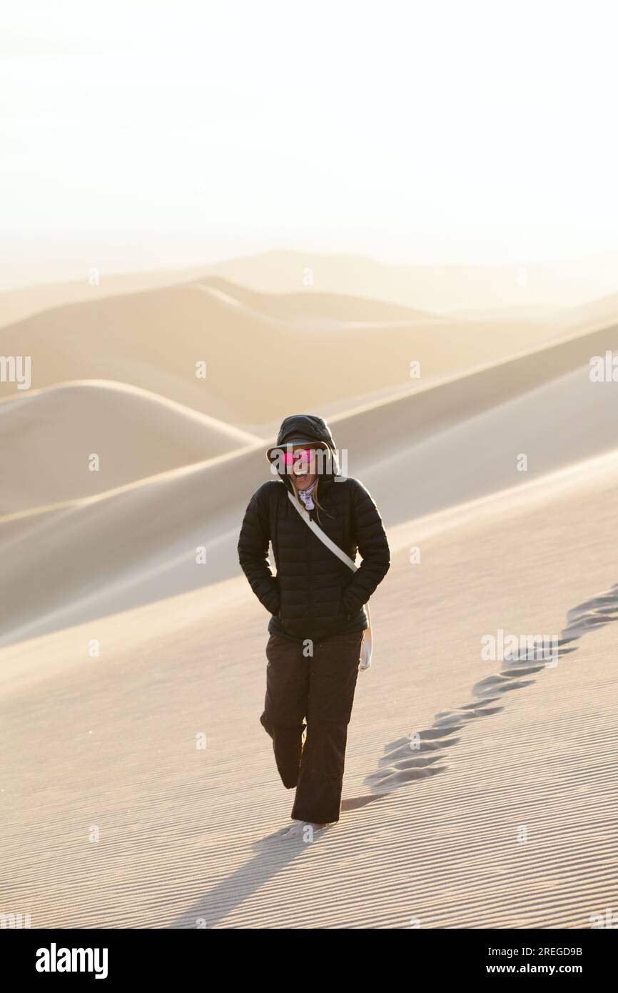 laughing female wanderer walking in the desert of colorado Stock Photo ...