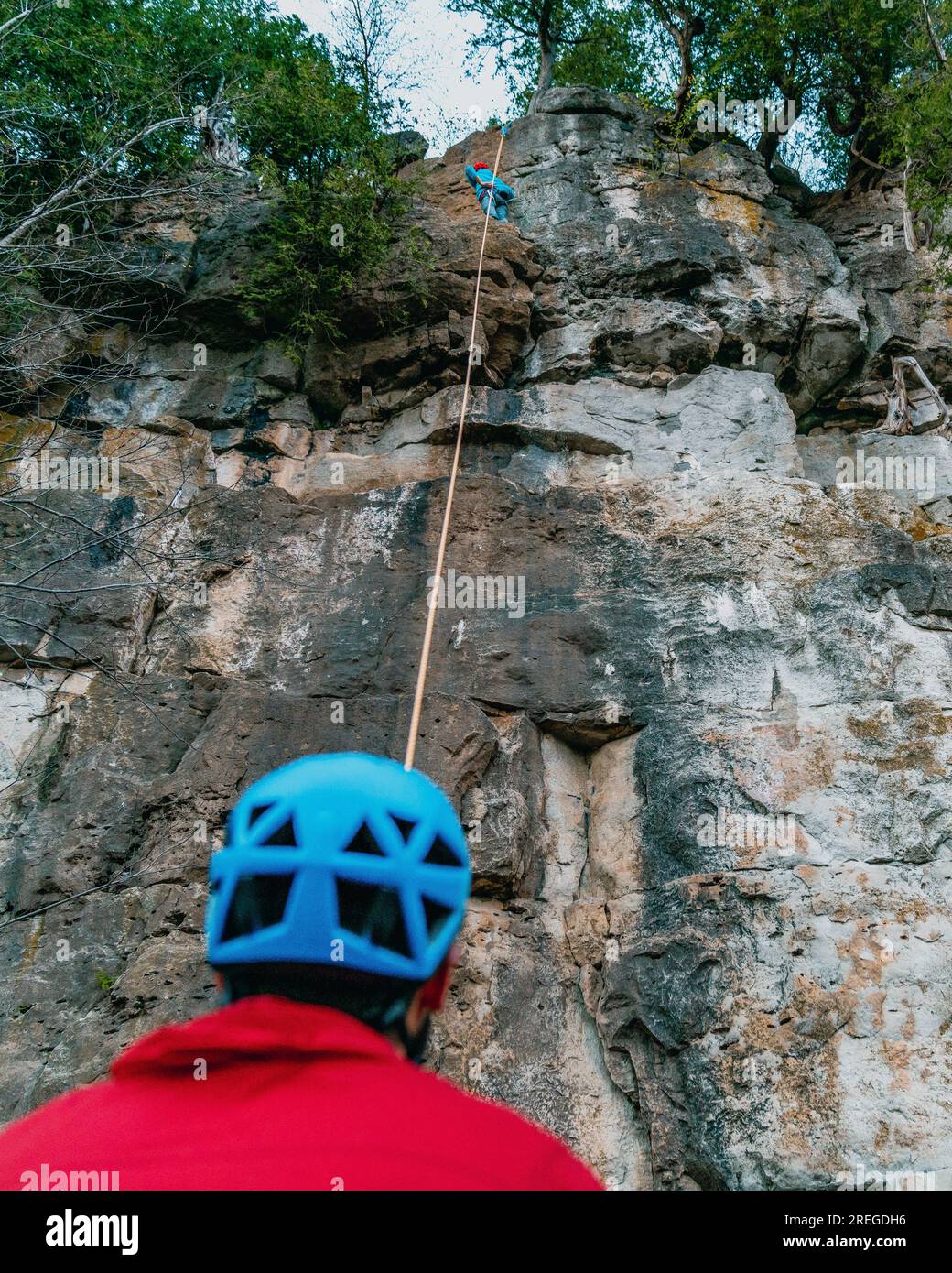 Climbing Partners Top Out in Ontario Crag Stock Photo - Alamy