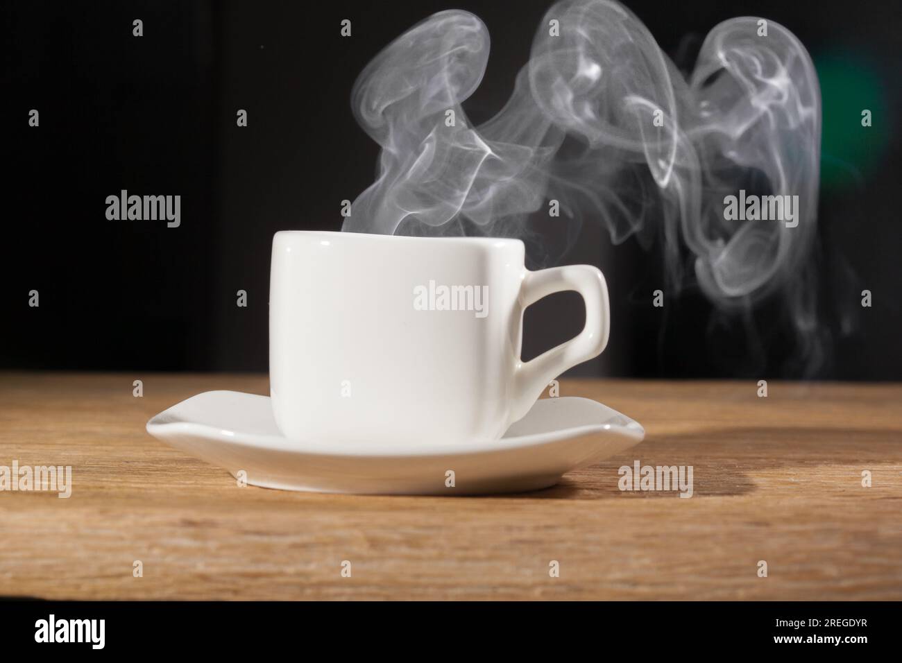 steam cup of hot coffee on an oak table Stock Photo - Alamy