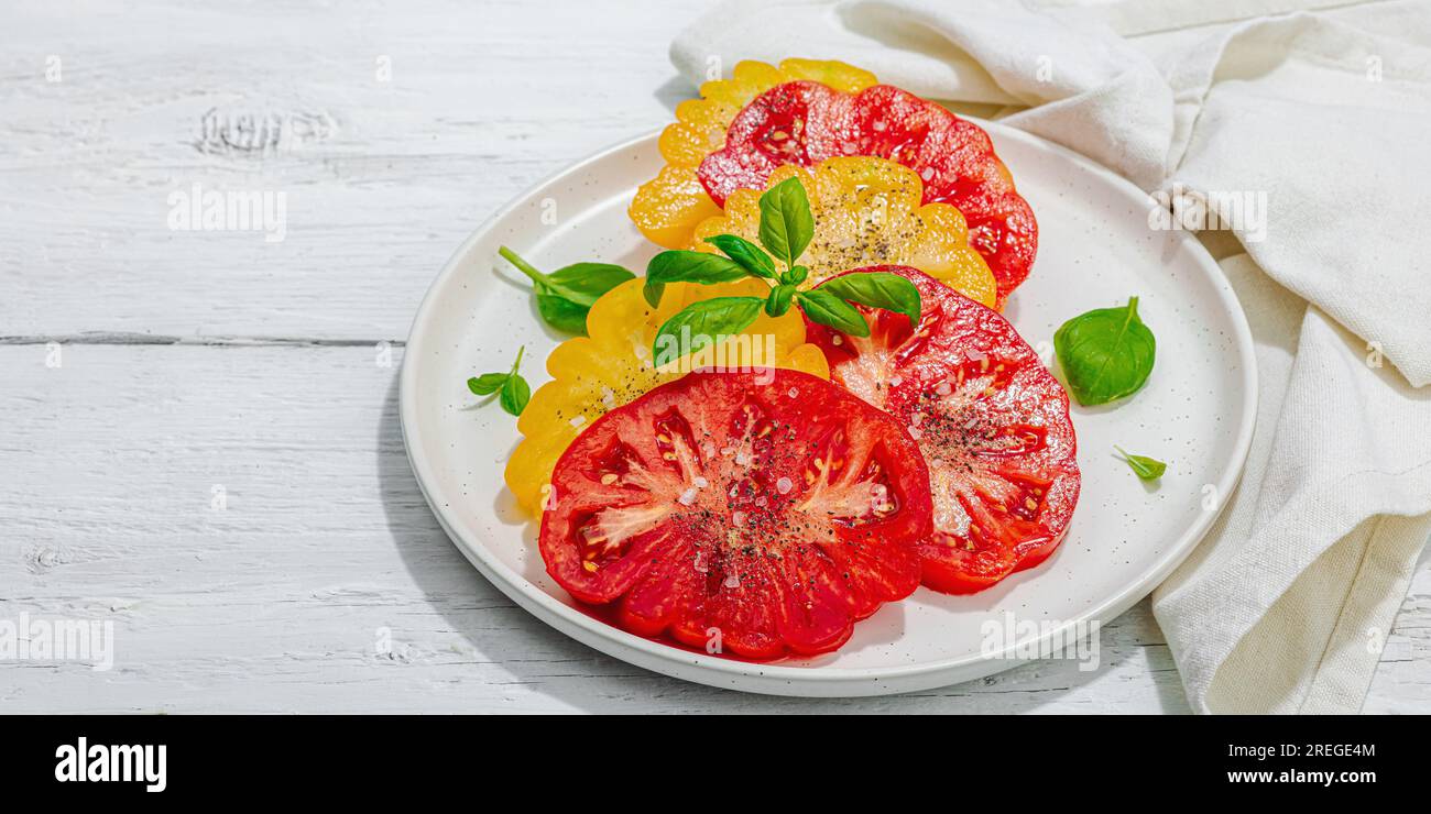 Colorful Heirloom tomato harvest. Ripe ribbed vegetables with fresh ...