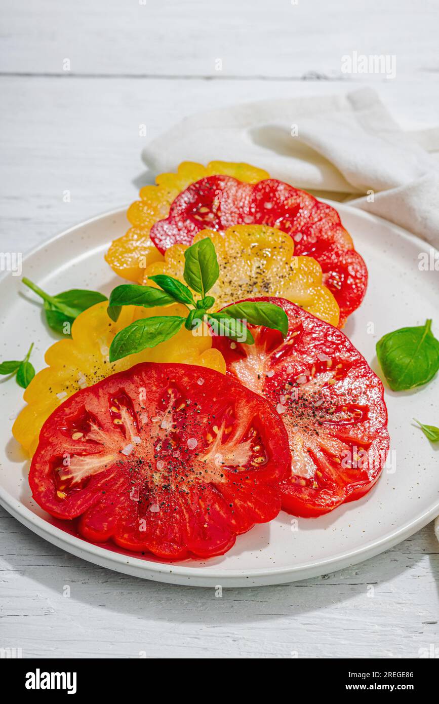 Colorful Heirloom tomato harvest. Ripe ribbed vegetables with fresh ...