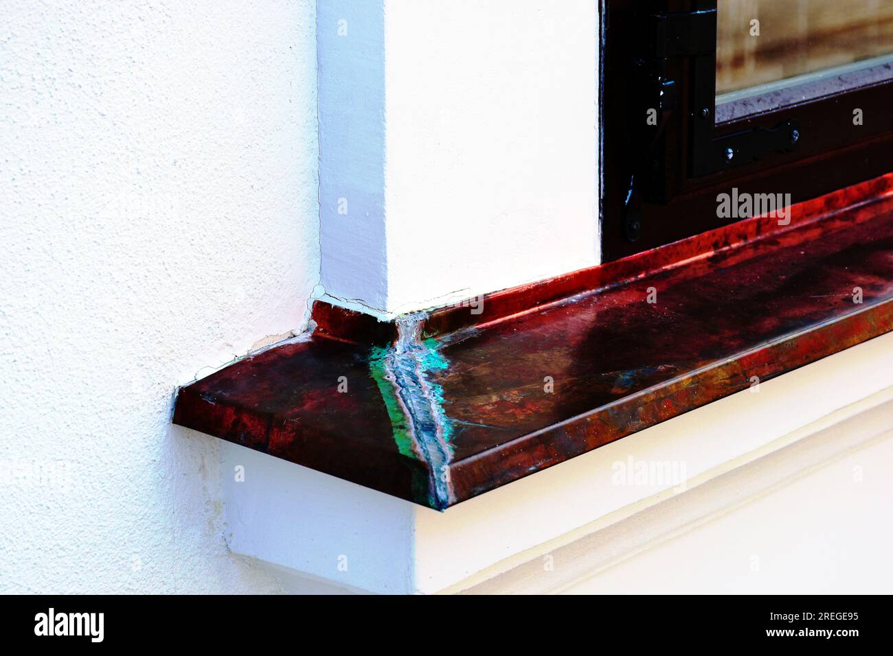 shiny red copper plate welded window sill. brown wood window frame ...