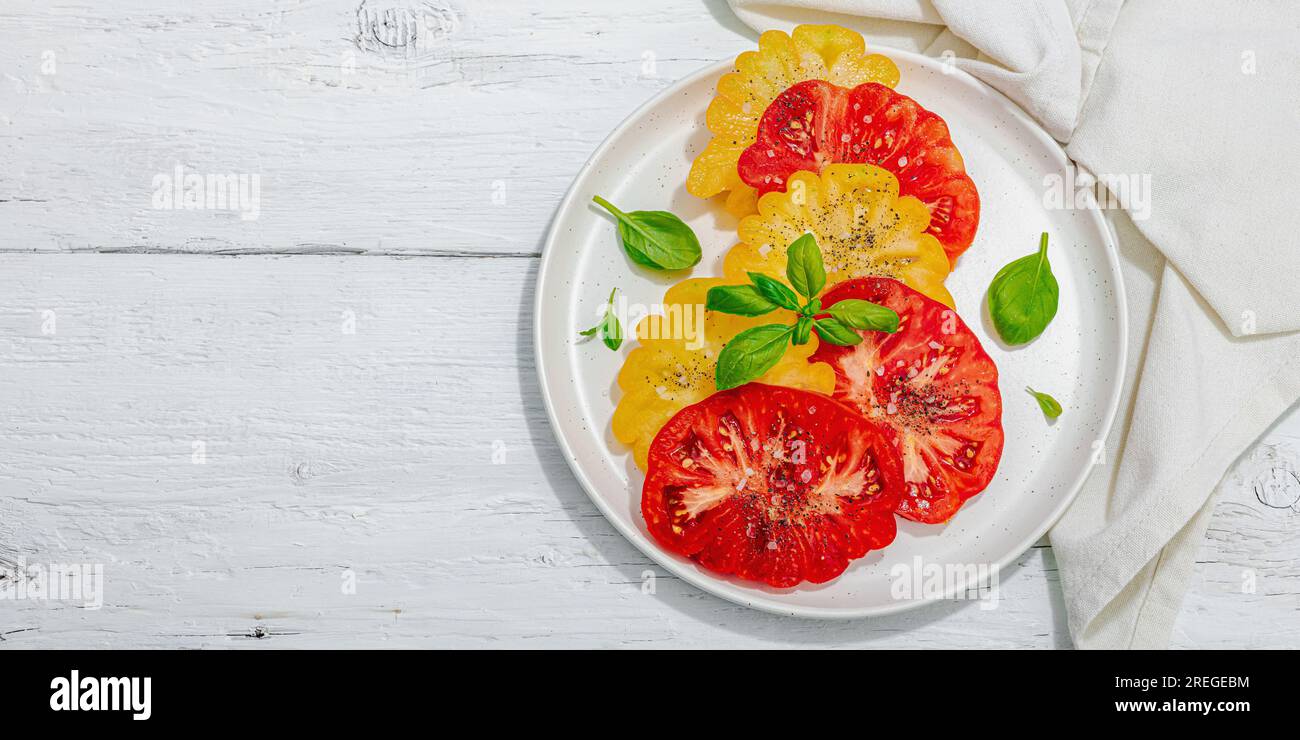 Colorful Heirloom tomato harvest. Ripe ribbed vegetables with fresh ...