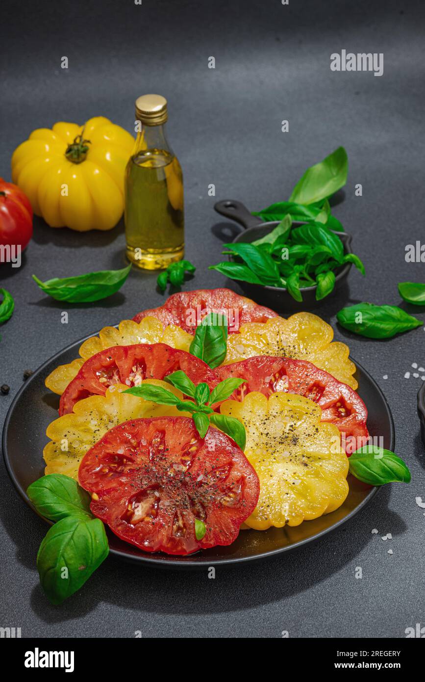 Colorful Heirloom tomato harvest. Ripe ribbed vegetables with fresh ...