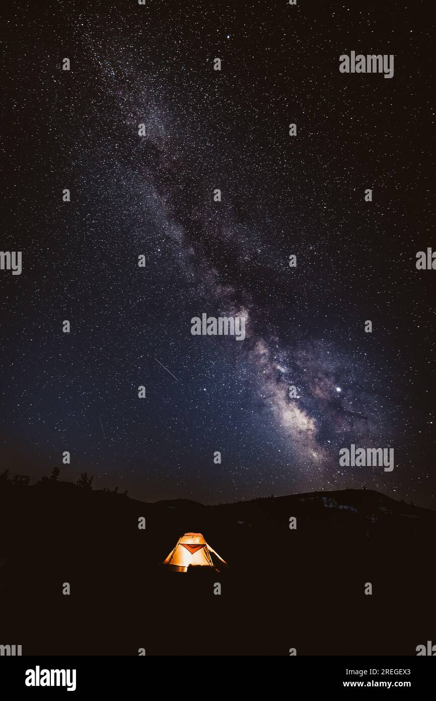 astrophotography of glowing tent at a campsite under milky way galaxy ...