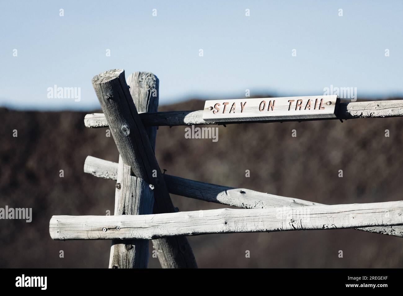 stay on trail sign on a old wooden hitch and post and beam fence Stock ...