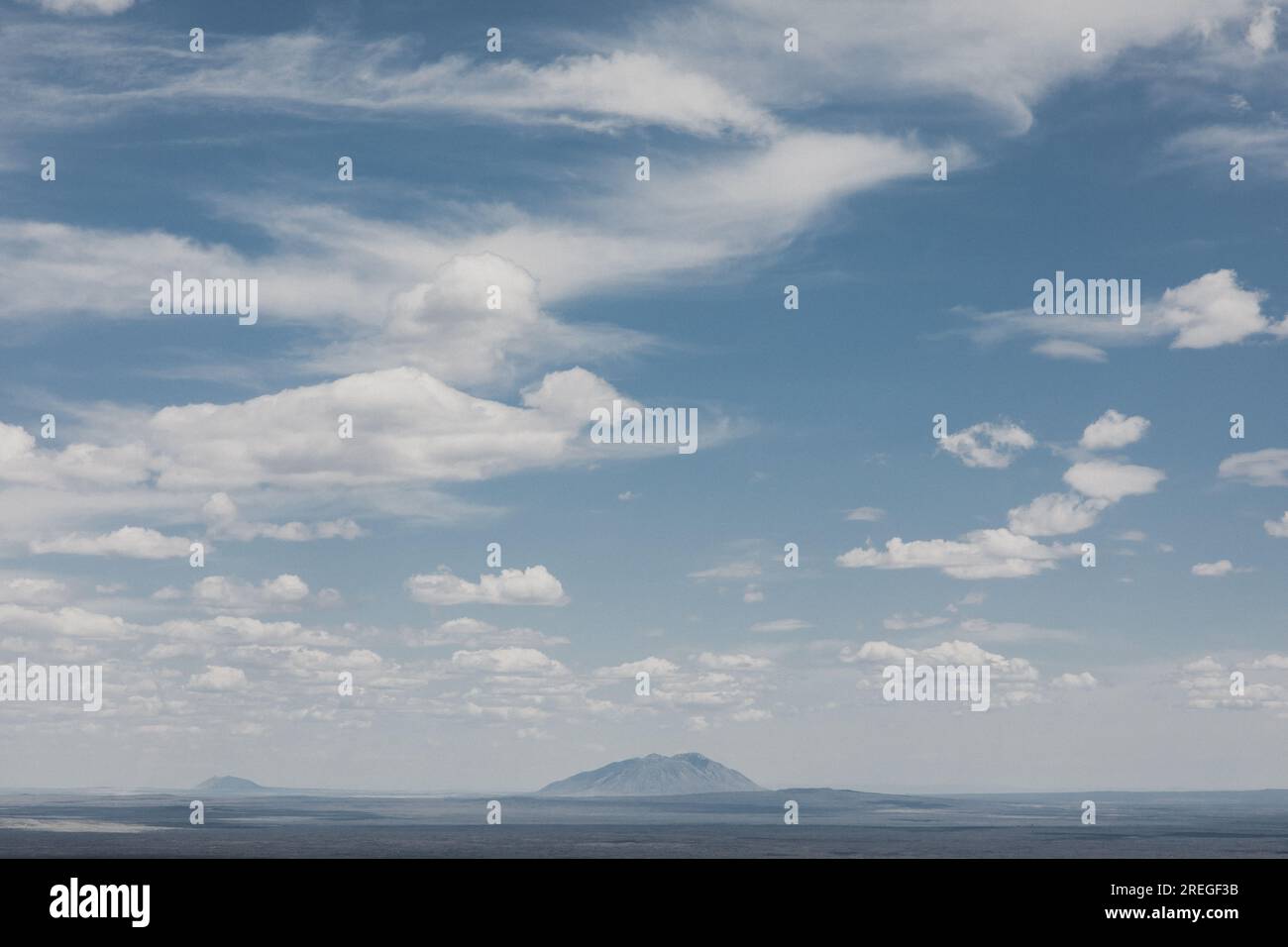 cloud and blue sky above the volcanic basin of the snake river plain ...