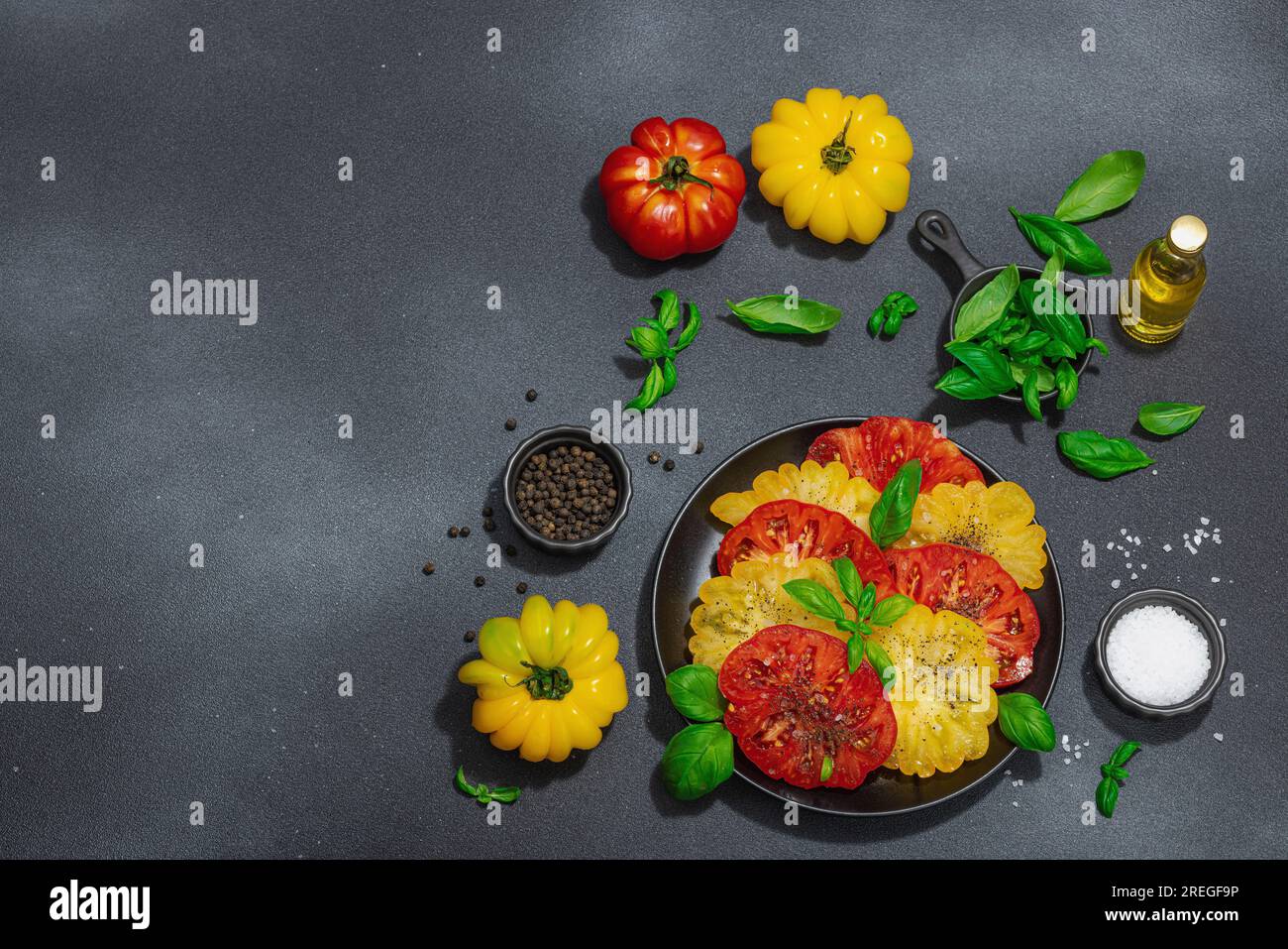 Colorful Heirloom tomato harvest. Ripe ribbed vegetables with fresh ...