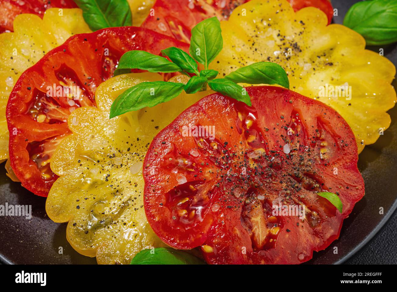 Colorful Heirloom tomato harvest. Ripe ribbed vegetables with fresh ...