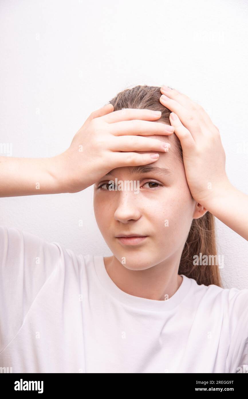 girl think about troubles, put hand on forehead and on head temple, don ...