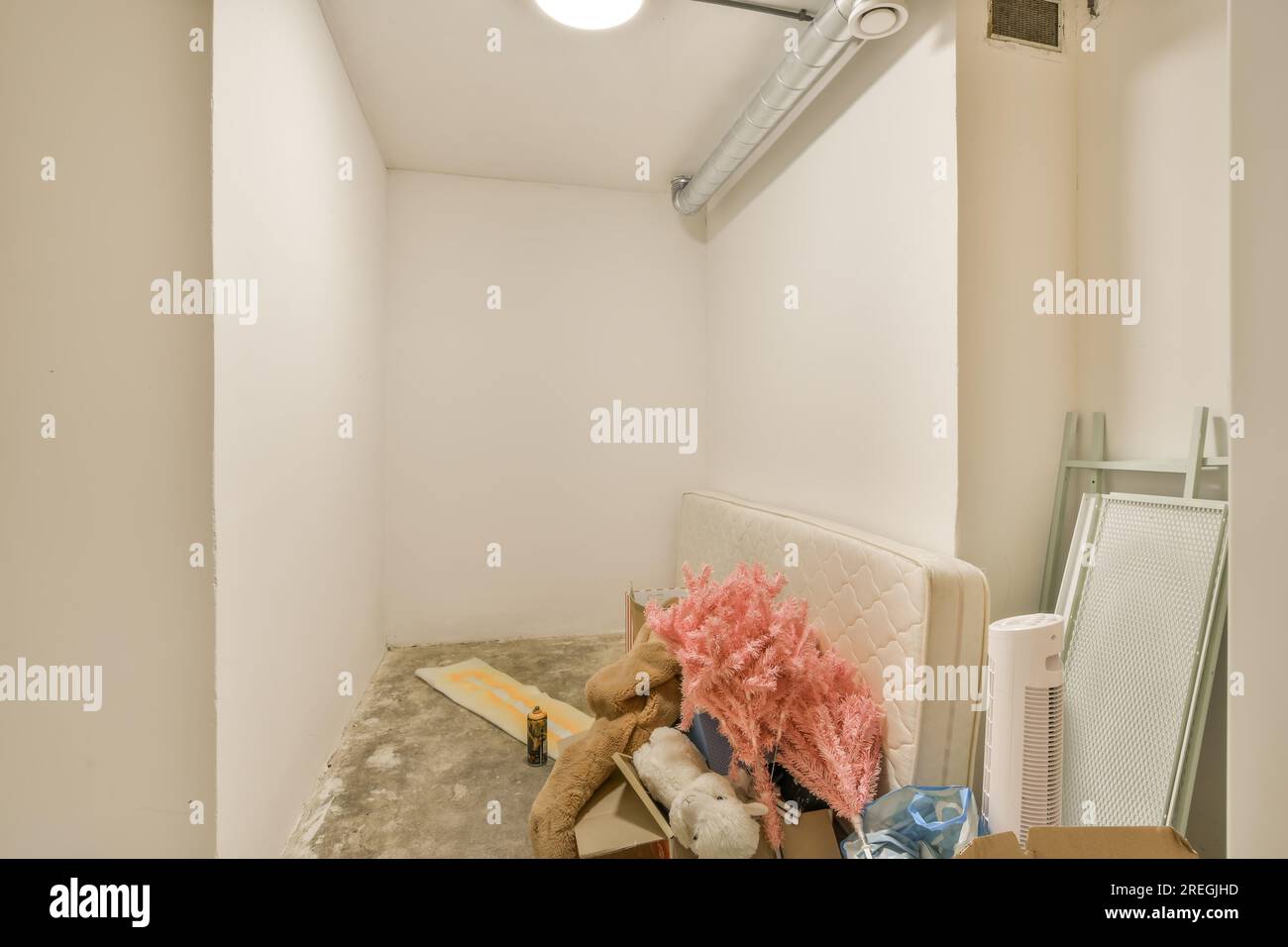 an unfinished room with some stuff on the floor and a bunch of pink ...
