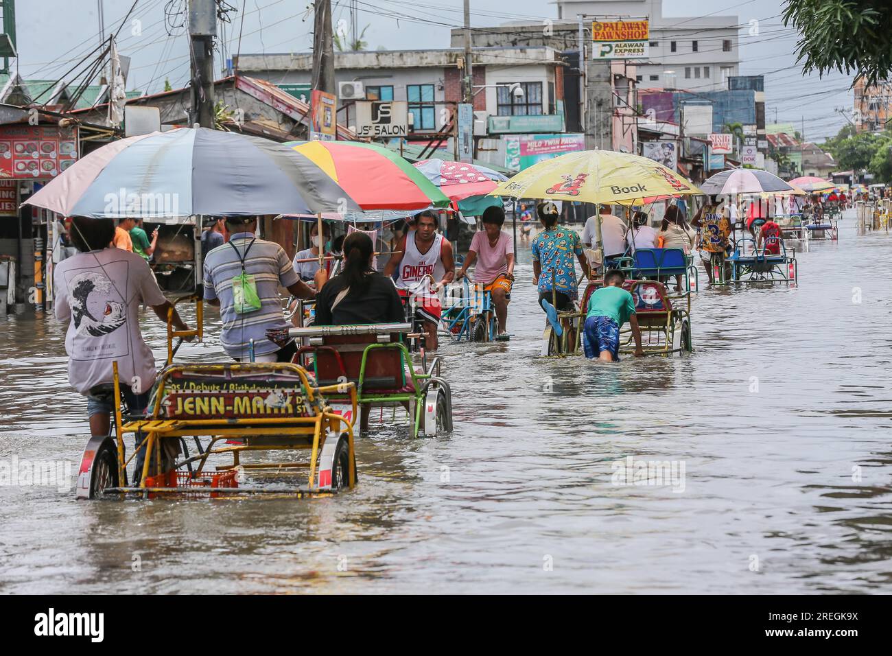 Valenzuela City, Philippines. 28th July, 2023. People ride on a ...