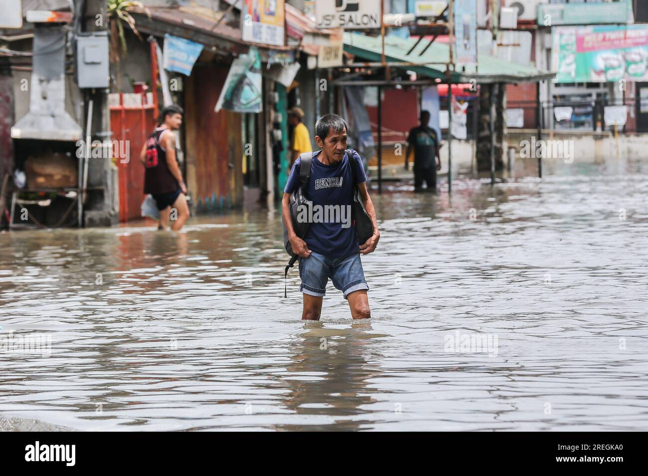 Valenzuela City, Philippines. 28th July, 2023. A man wades through ...