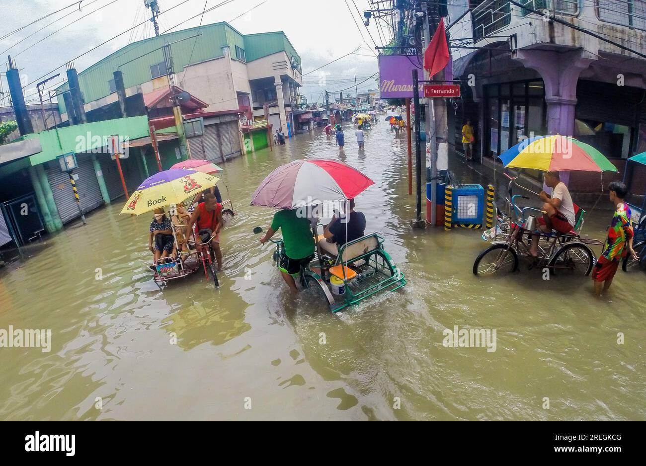 Valenzuela City, Philippines. 28th July, 2023. People ride on a ...