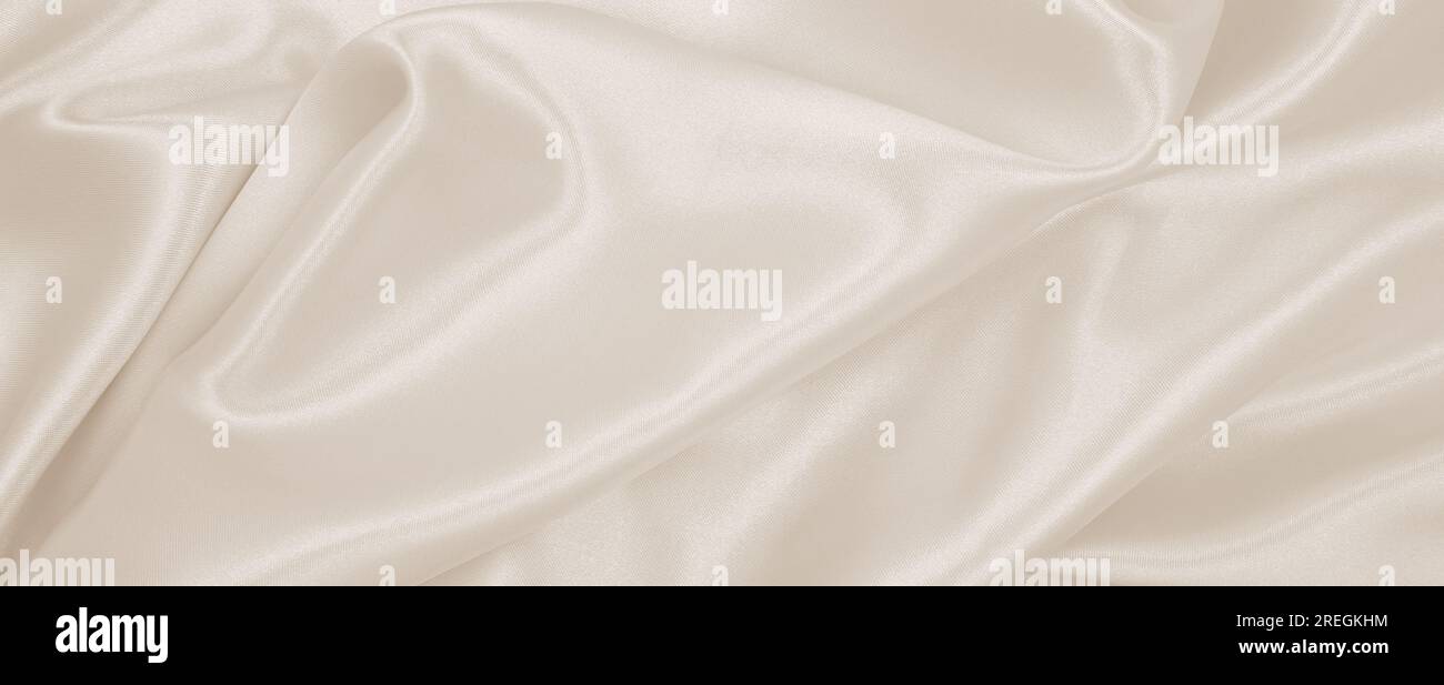 Smooth elegant golden silk or satin luxury cloth texture can use as ...