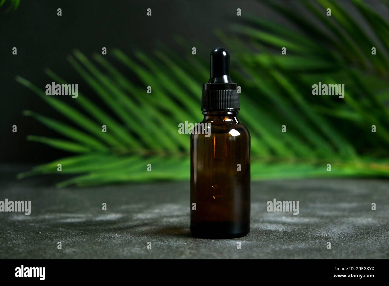 Drop of clear liquid, oil, serum or tincture dripping from pipette in ...