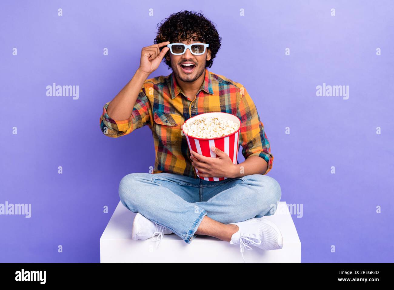 Full size portrait of astonished person sit podium hold popcorn bucket ...