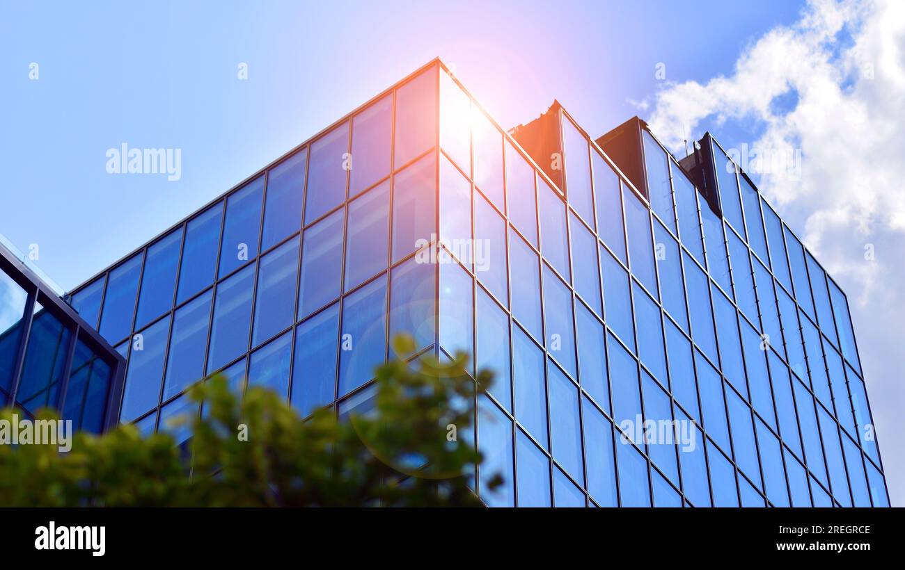 Reflection of modern commercial building on glass with sunlight. Eco ...