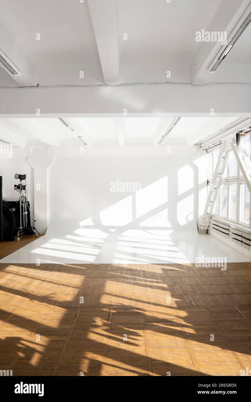 Clean big white cyclorama in a photo studio with a sunlight and shadows ...